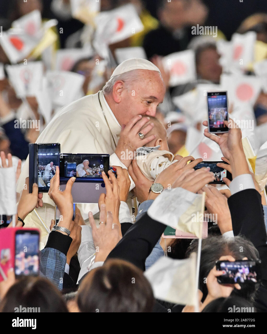 Pope Francis kisses a child in Popemobile based by hydrogen fuel cell ...