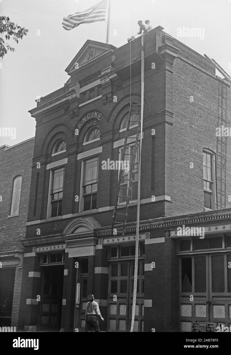 Fireman stands in front of Engine Company #8 fire station ca. 1921-1923 ...