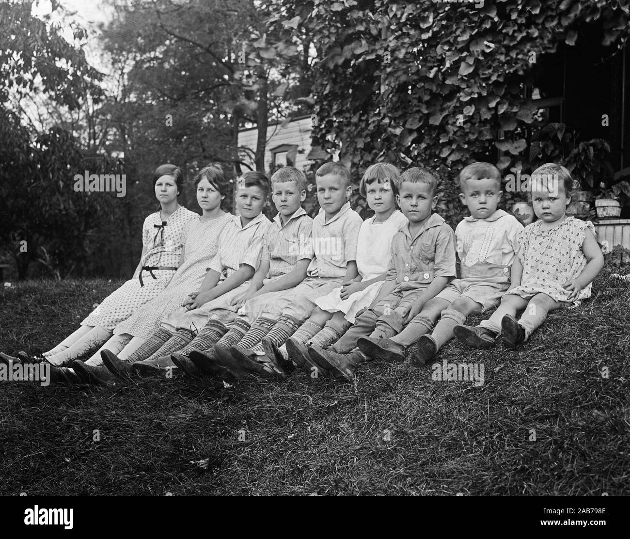 Nine children sitting for a portrait ca. 1927 Stock Photo - Alamy