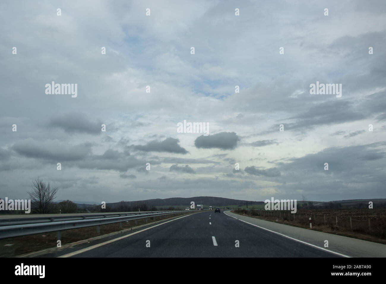 Bulgarian highway with cars and truck, asphalt road with road signs on ...