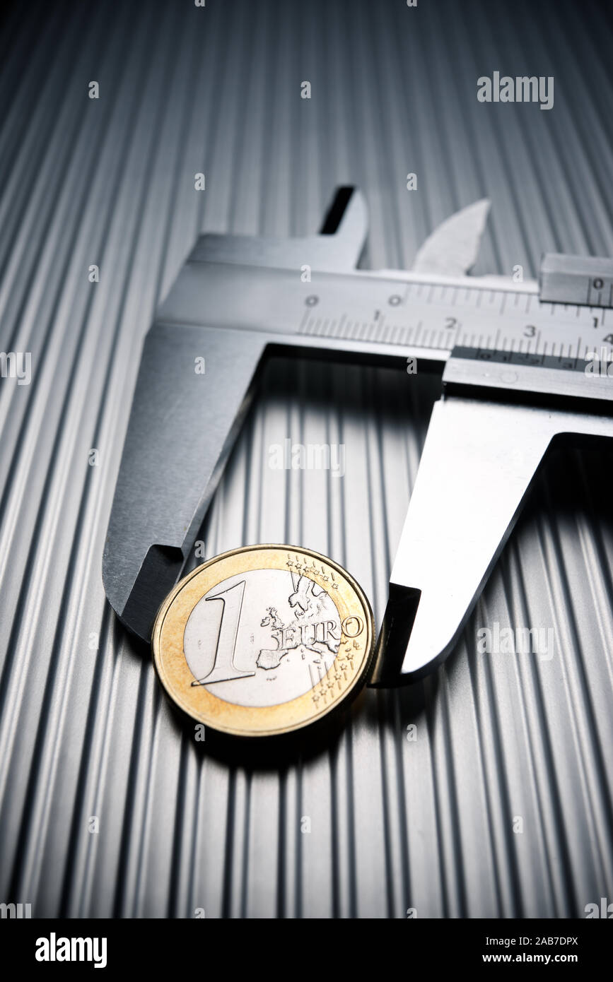 metal gauge measuring a one euro coin on a metal surface Stock Photo ...