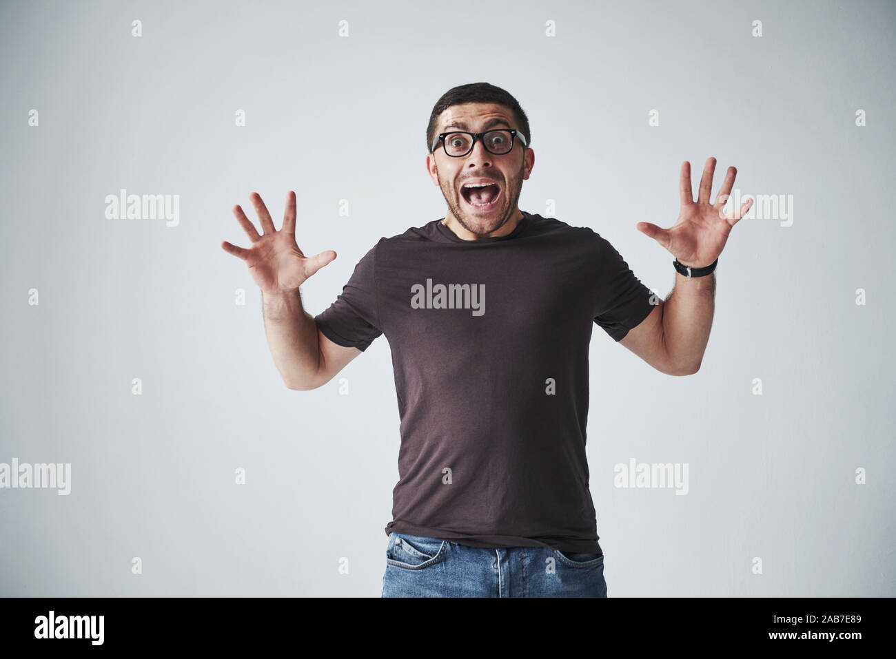 Emotional man in casual clothes screams in pain or with fear. His ...