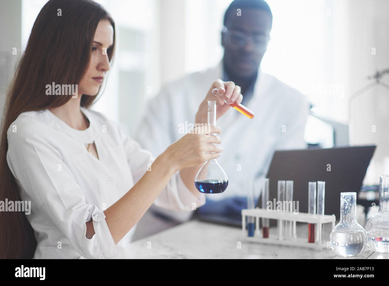 Scientists work closely with the microscope in the laboratory by ...