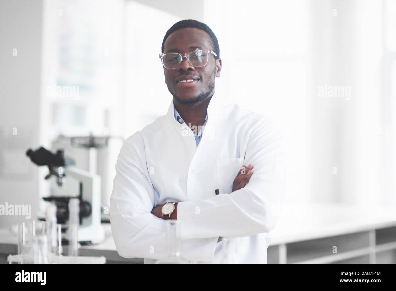 An African American worker works in a laboratory conducting experiments ...
