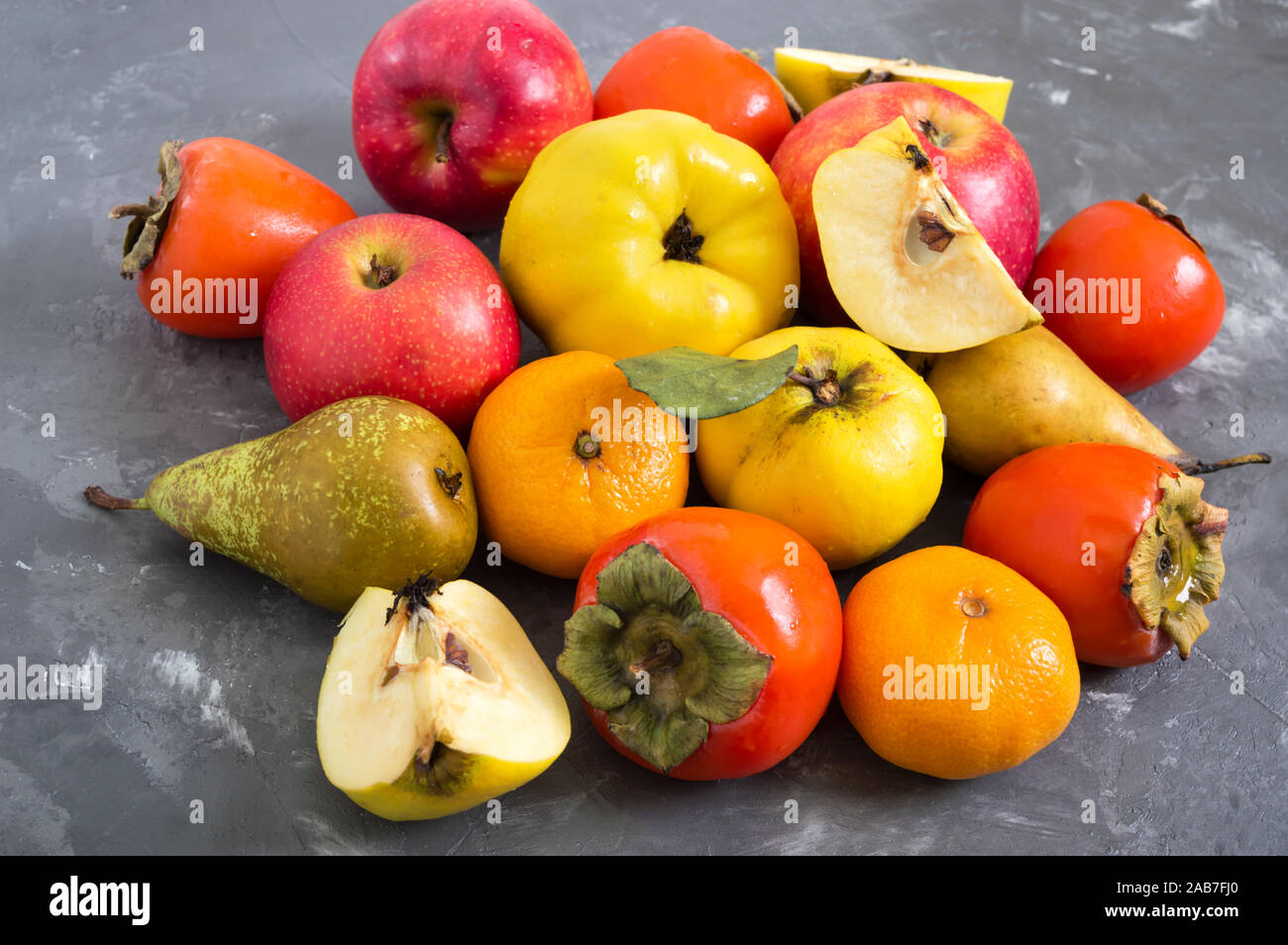 Different seasonal fruits on a concrete background. Source of vitamins ...