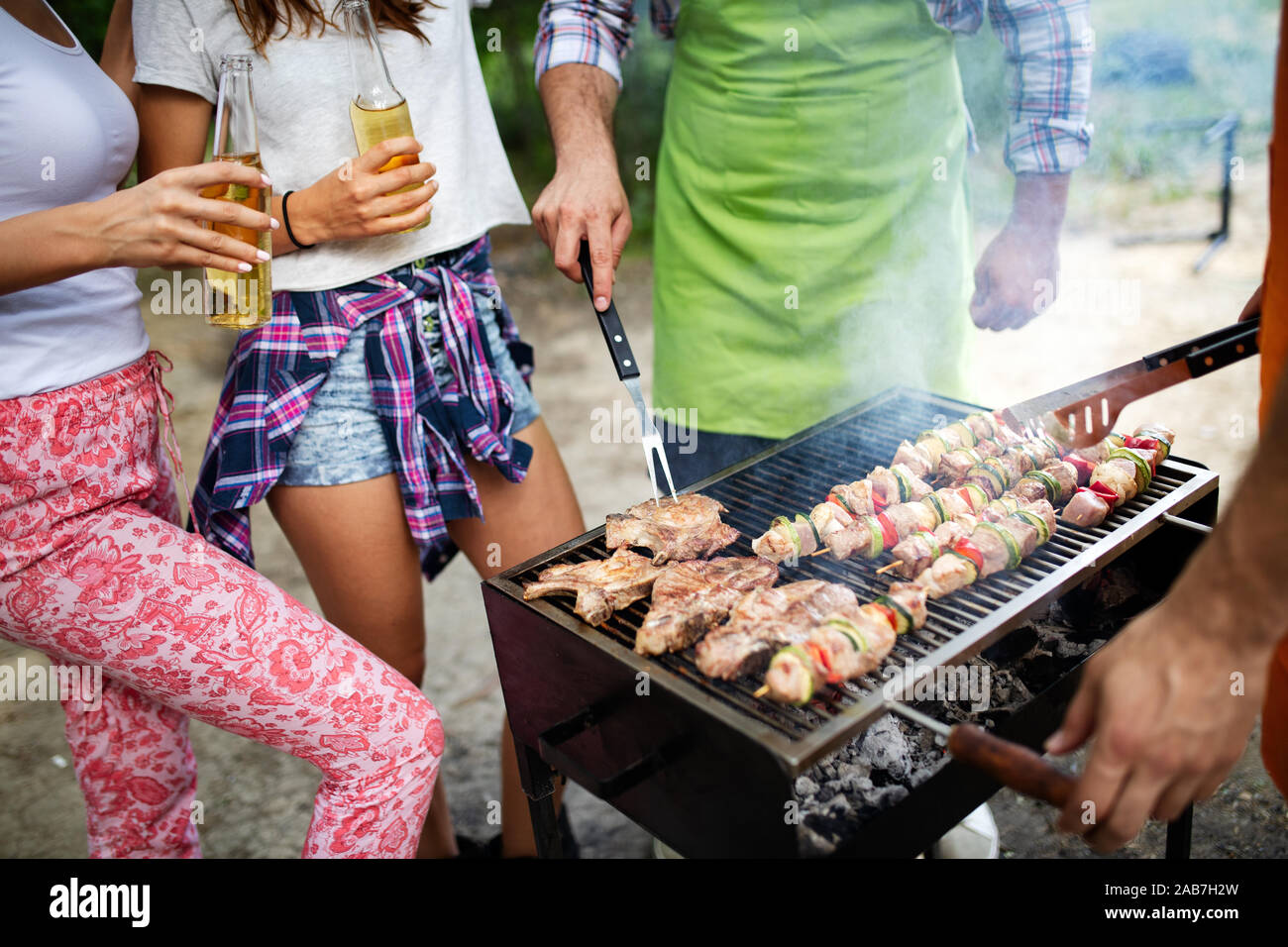 Small group of friends having fun at barbecue party Stock Photo - Alamy