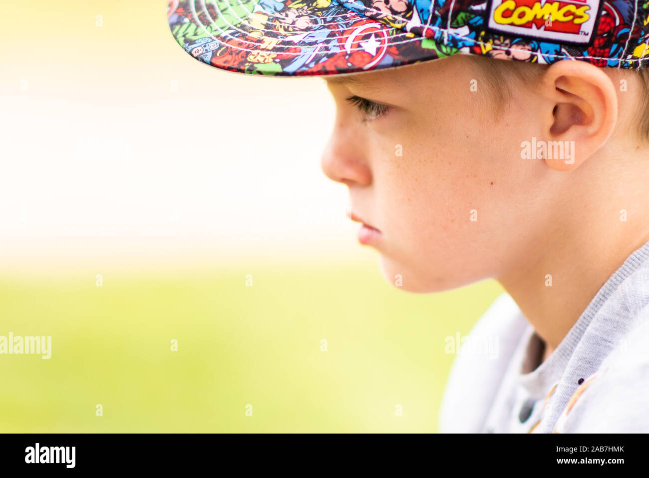 A handsome boy with ADHD, Autism, Asperger Syndrome sitting at the park ...