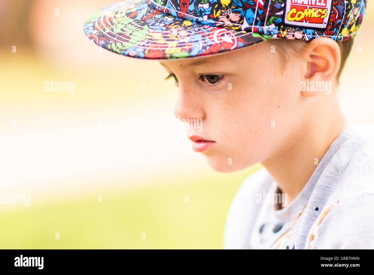 A handsome boy with ADHD, Autism, Asperger Syndrome sitting at the park ...