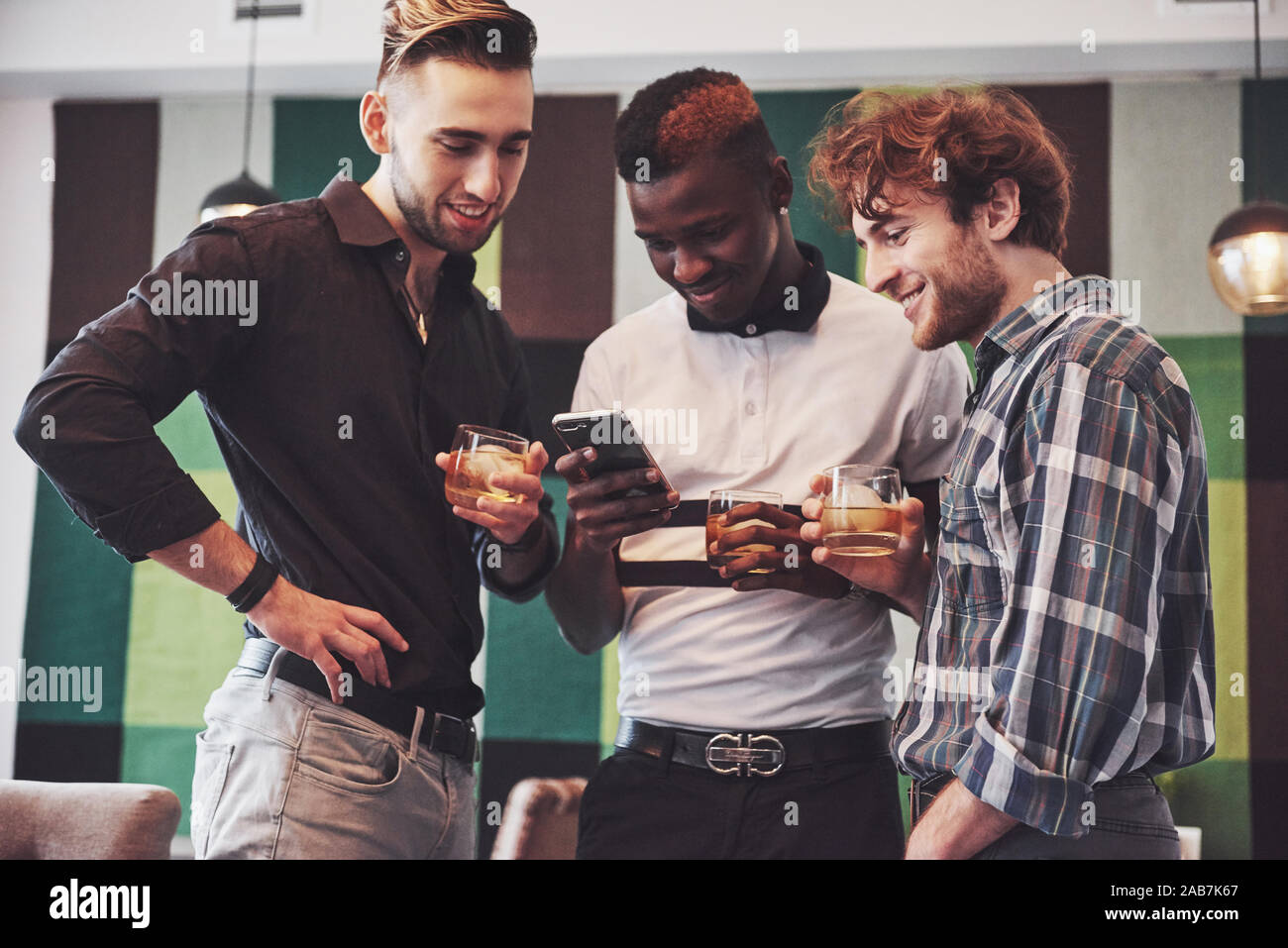 promising young multi ethnic people celebrating and drinking whiskey ...