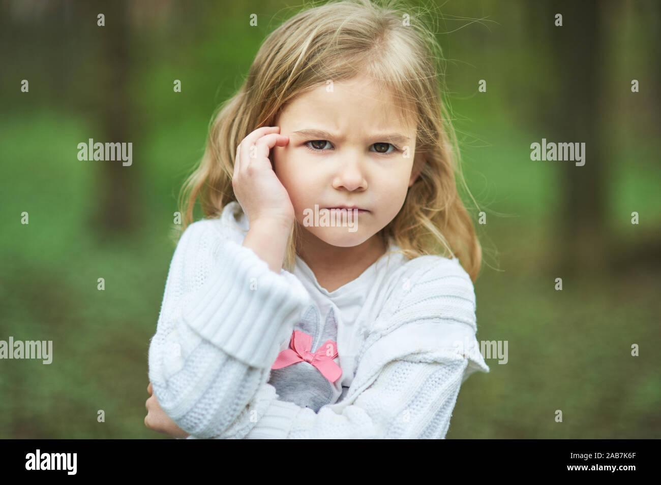 Portrait of sad unhappy little girl. Little sad child is lonesome ...