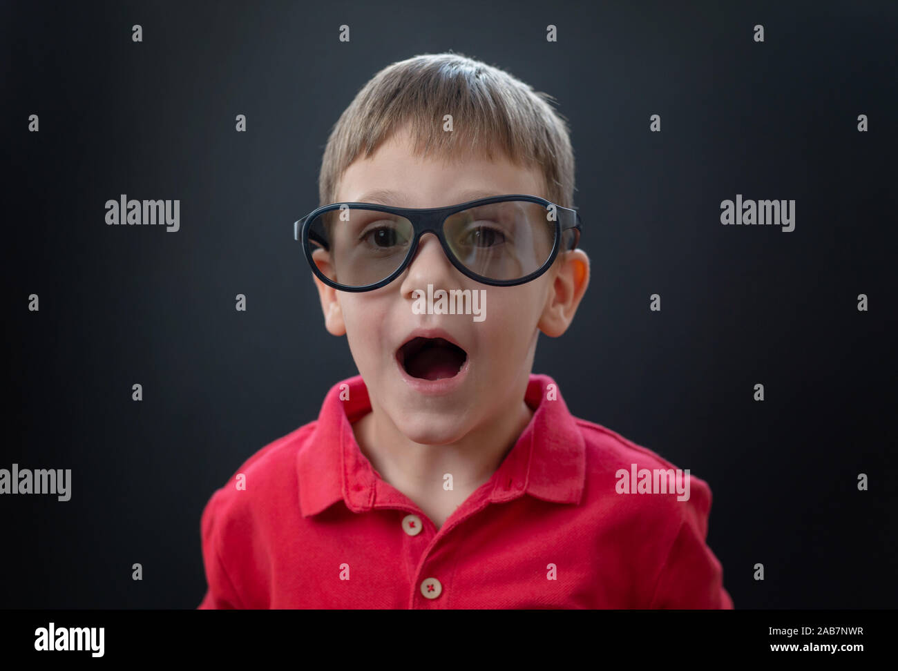 Boy with cinema 3d glasses with delighted face expression. Back ...