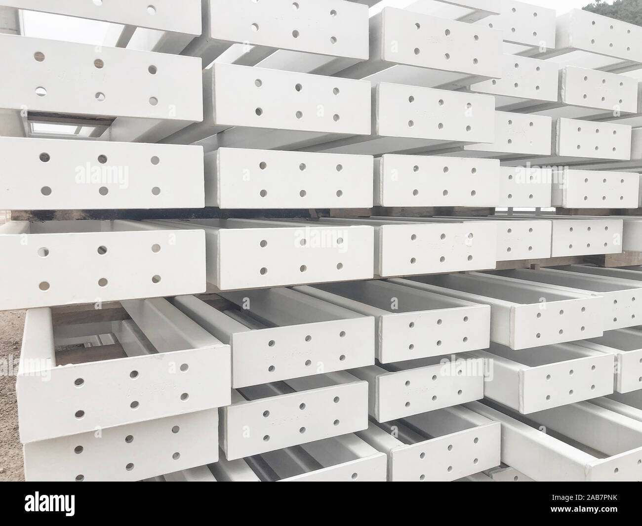 White colored metal girders. Stacked metal parts of a pre-fabricated ...