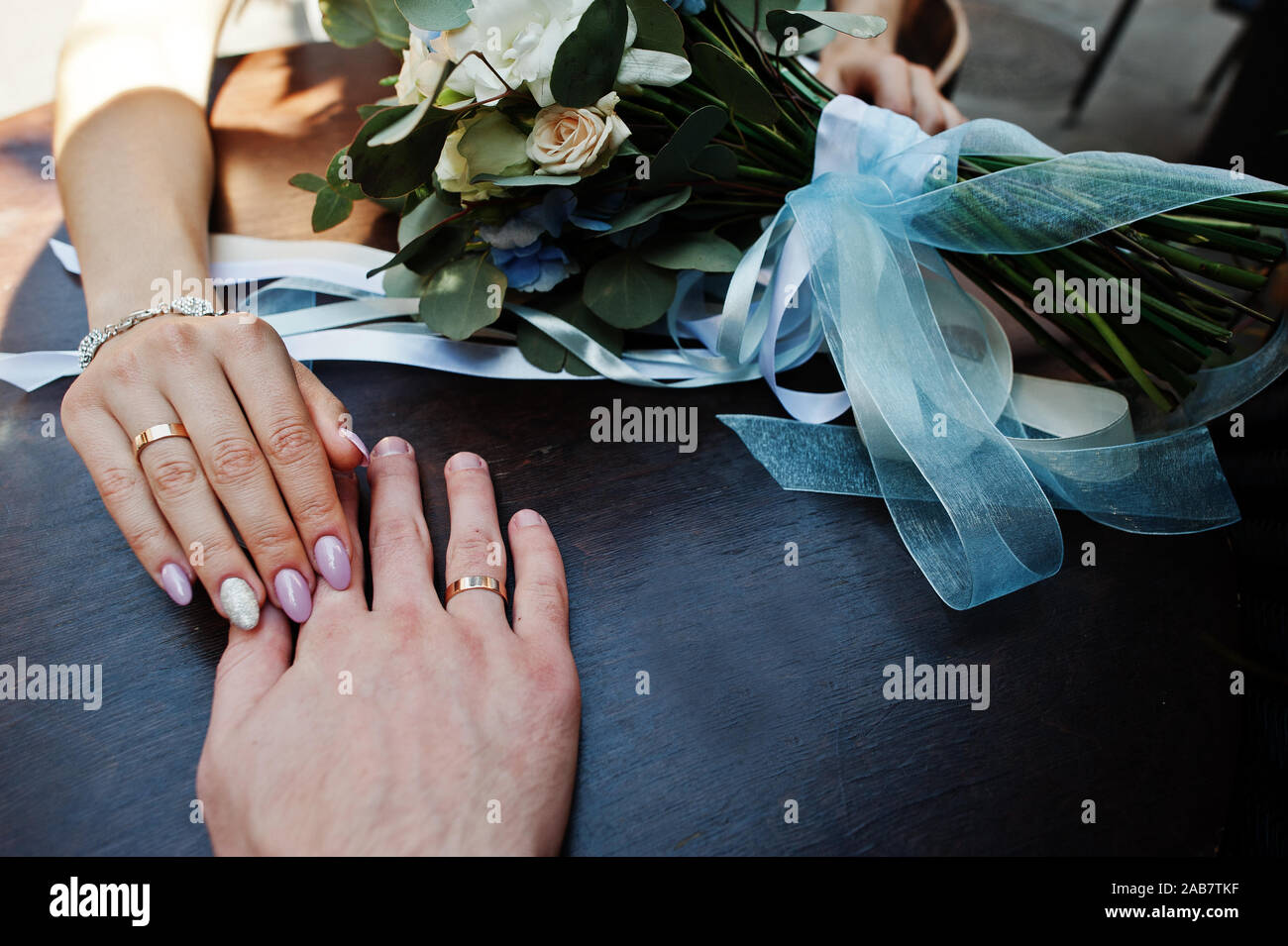 Wedding day. Hands in hands of newlywed couple Stock Photo - Alamy