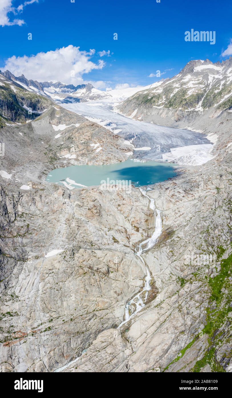 Aerial panoramic of Rhone Glacier and glacial lake at its base, Gletsch ...