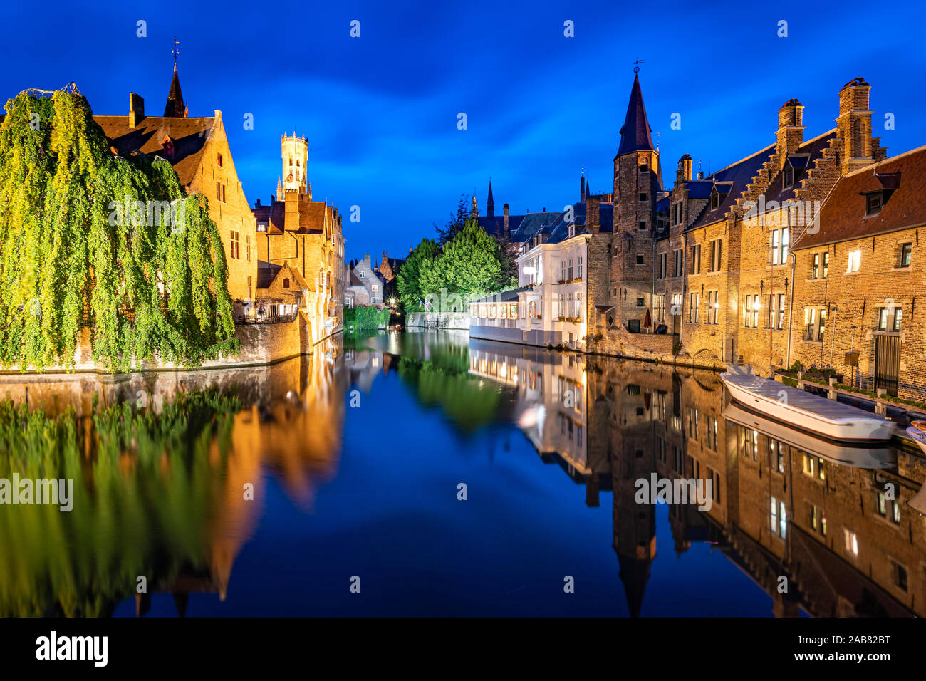 The beautiful buildings of Bruges reflected in the still waters of the ...