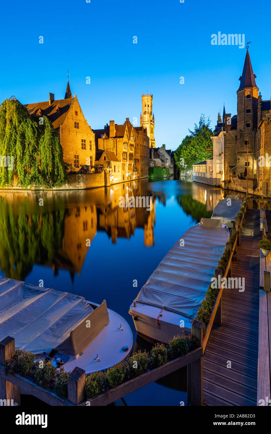 The beautiful buildings of Bruges reflected in the still waters of the ...
