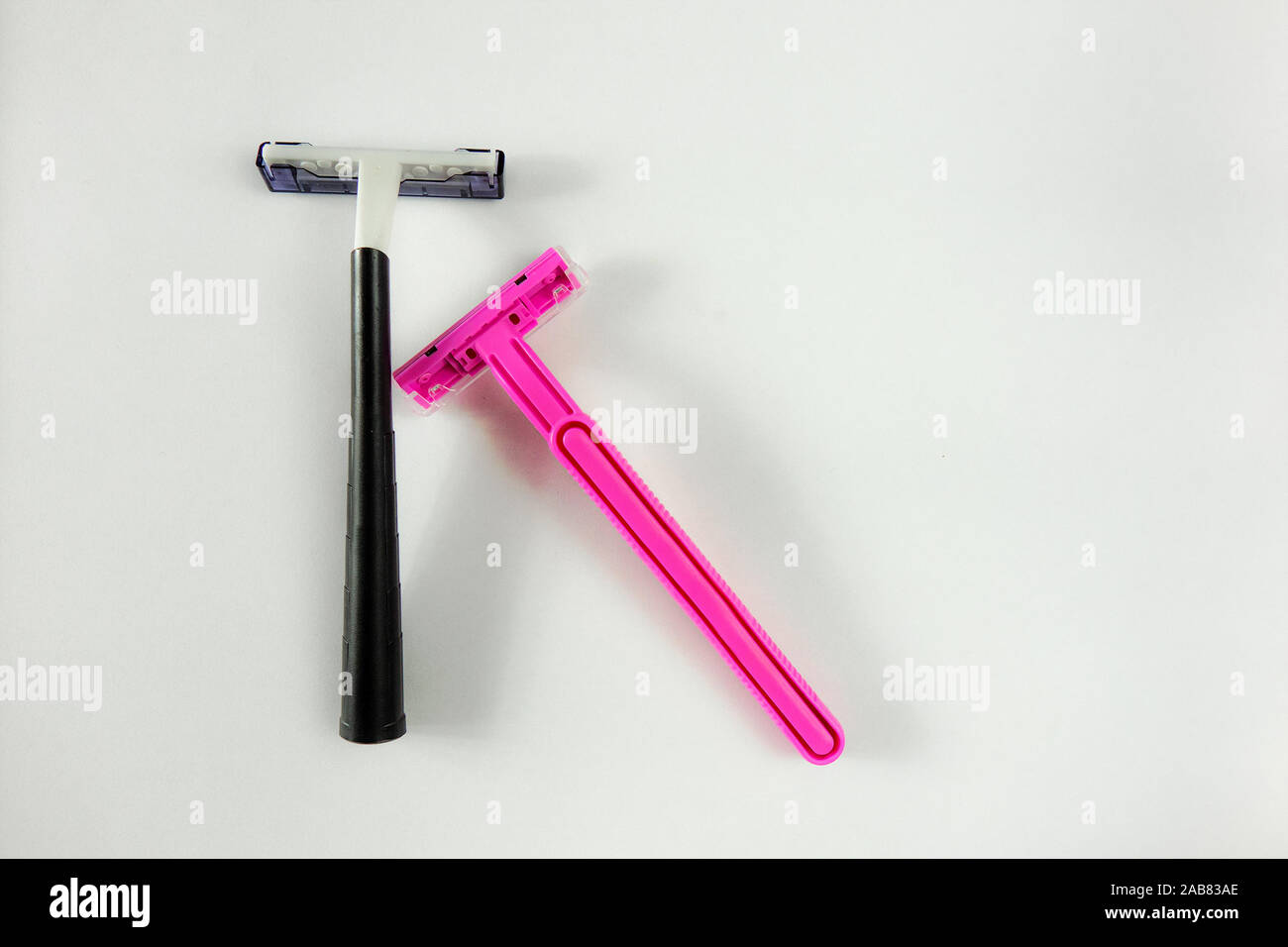 Two shaving sticks on light background with shadows. Pink for women and ...