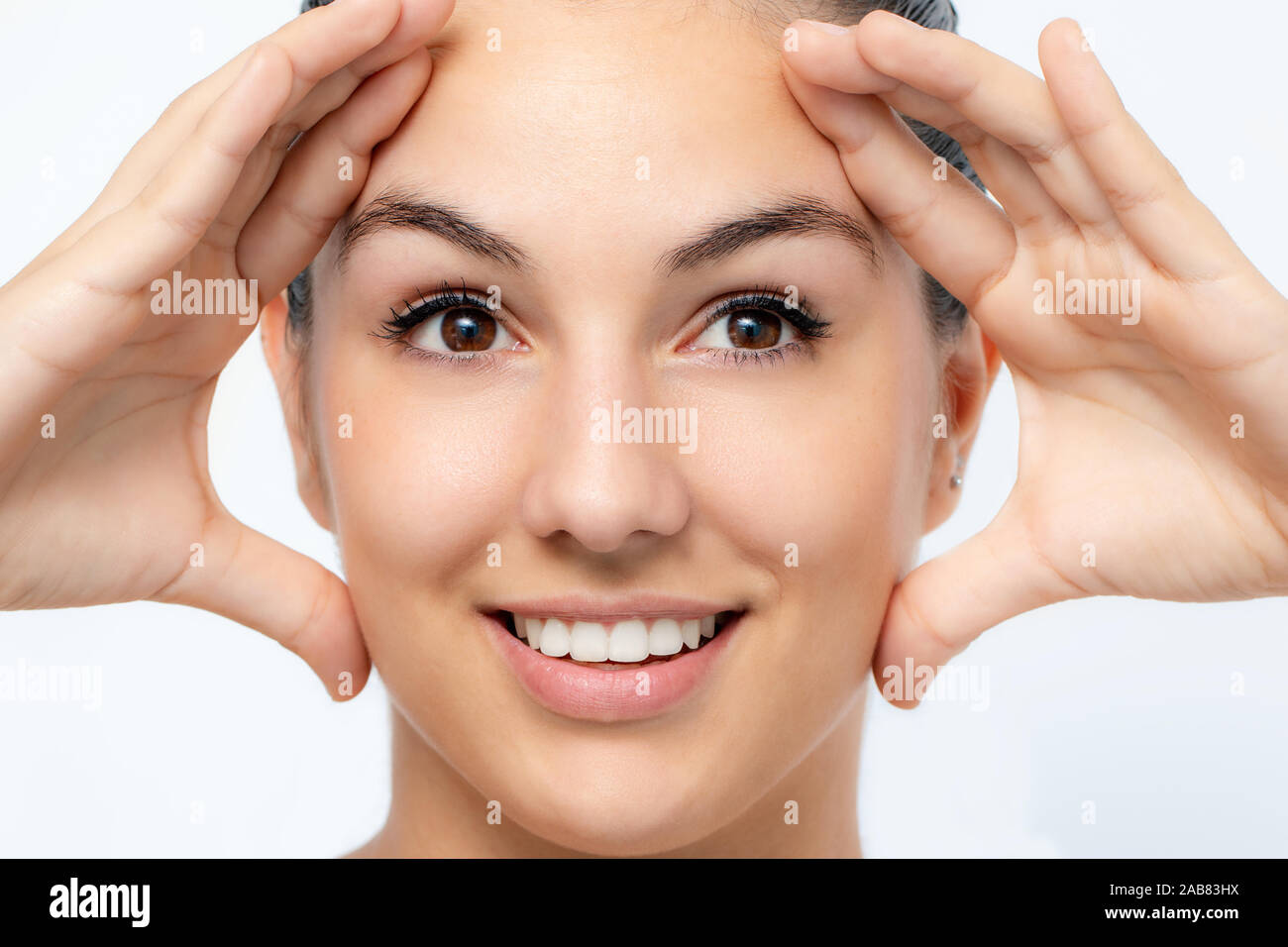 Macro close up beauty portrait of attractive young woman with fingers ...