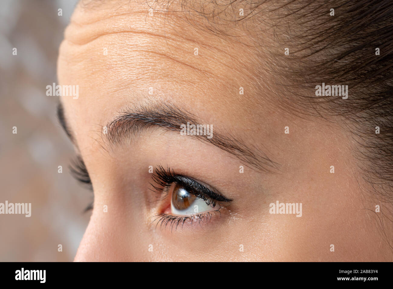 Close up detail of woman frowning forehead. Side view of girl showing ...