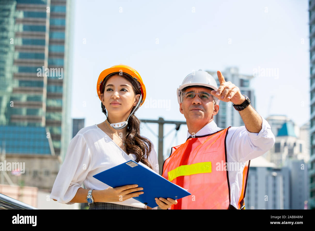 The engineer and business people hand high five against building. The ...