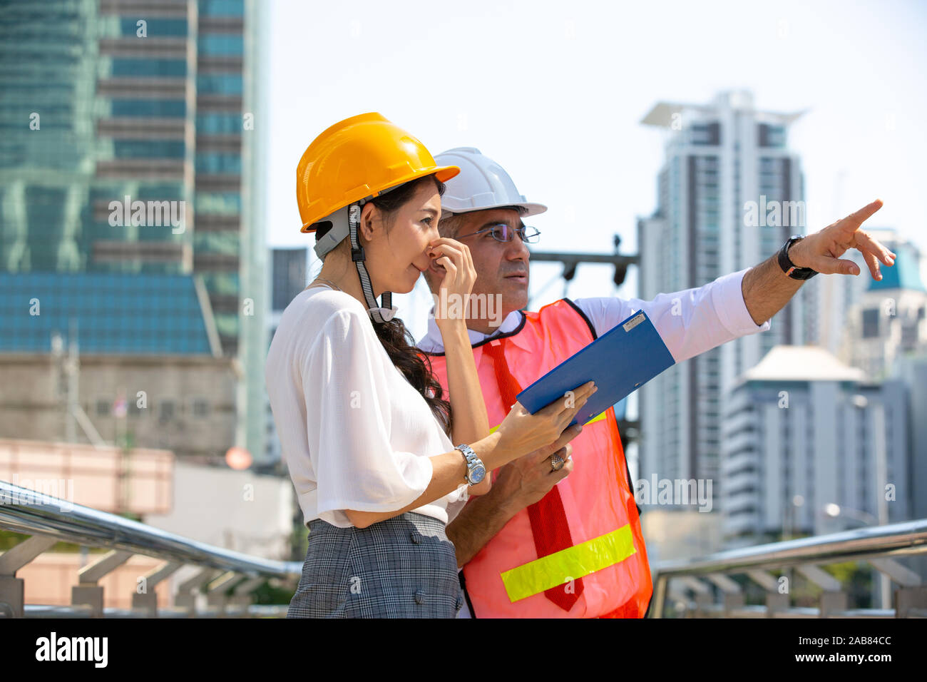 The engineer and business people hand high five against building. The ...
