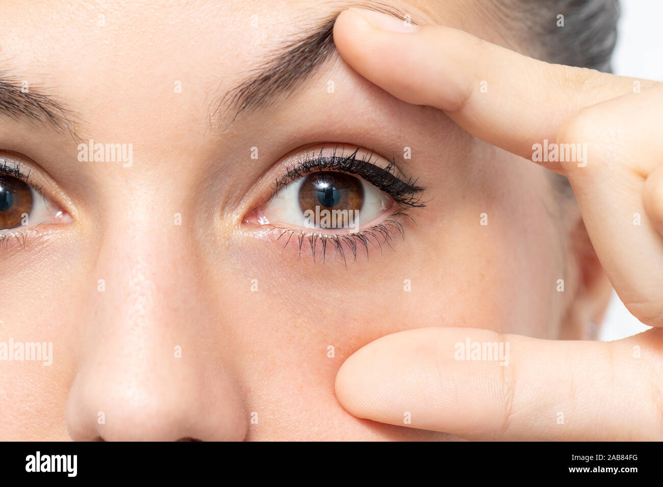 Macro detail of woman opening eye with fingers Stock Photo - Alamy