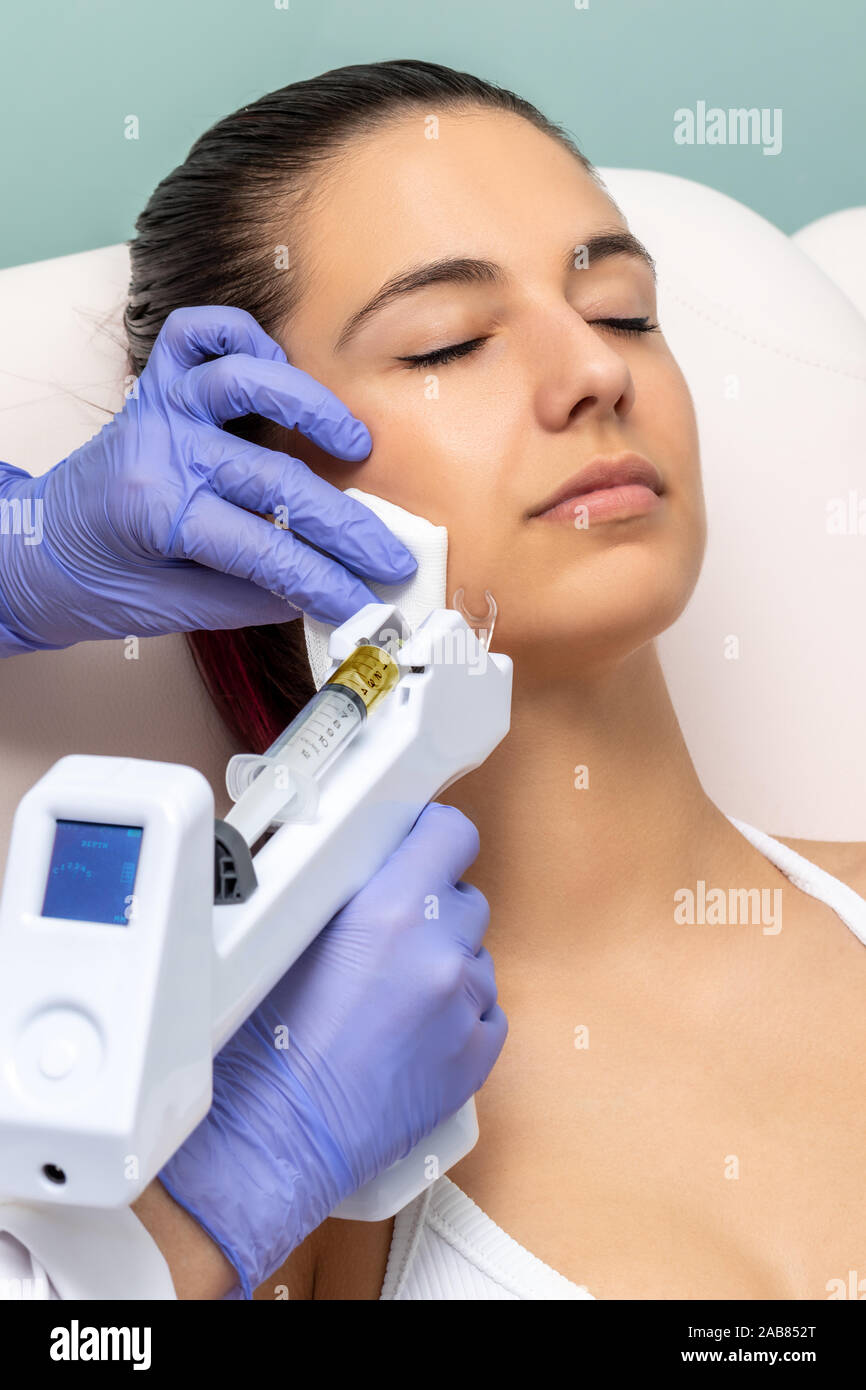 Woman having cosmetic facial plasma lift with micro needle gun Stock ...