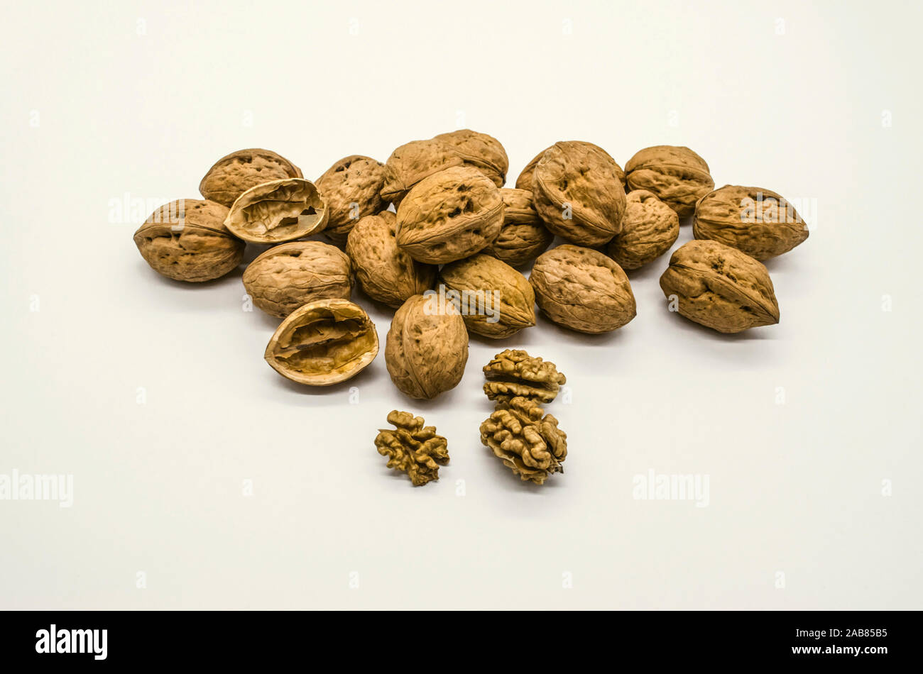 Peeled kernels with walnut shell halves with a bunch of ripe autumn ...