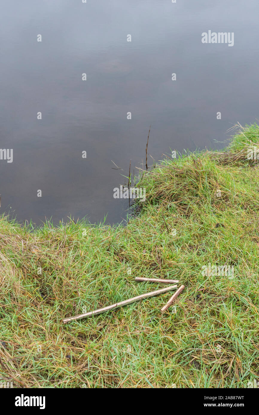 Survival skills concept. Signal arrow by river showing 'proceed this ...