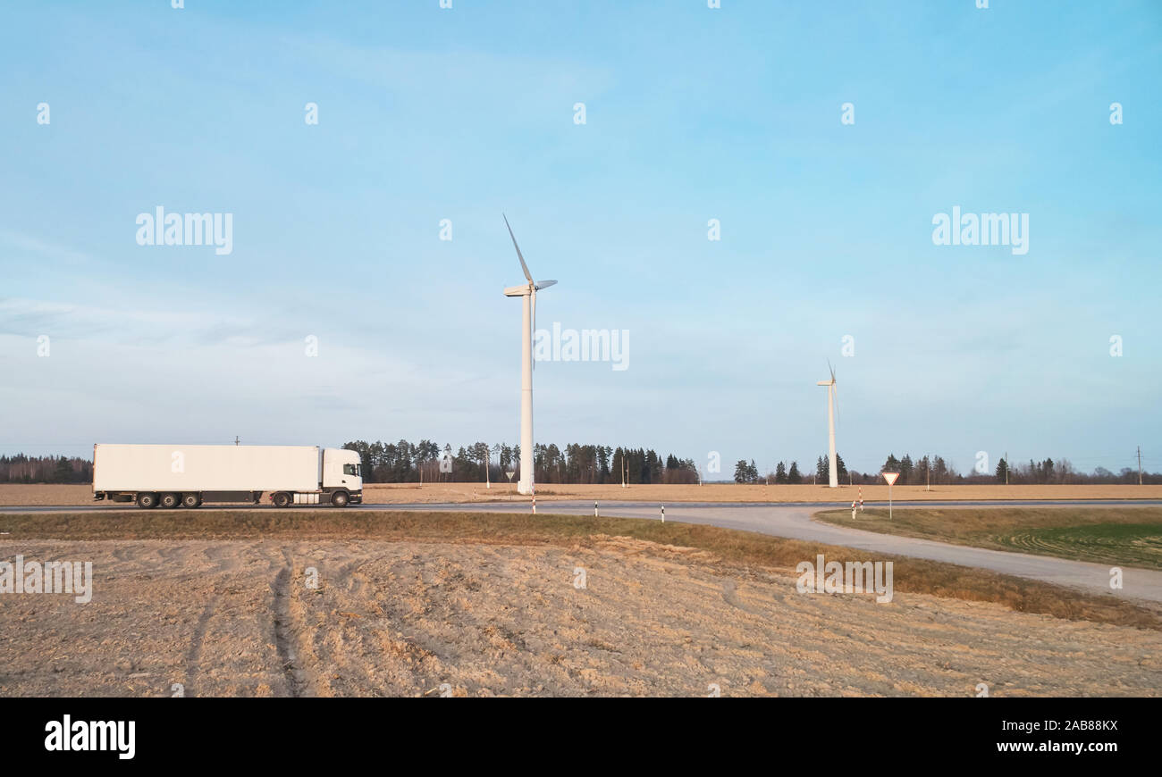 White semi truck carry load on landscape background Stock Photo - Alamy