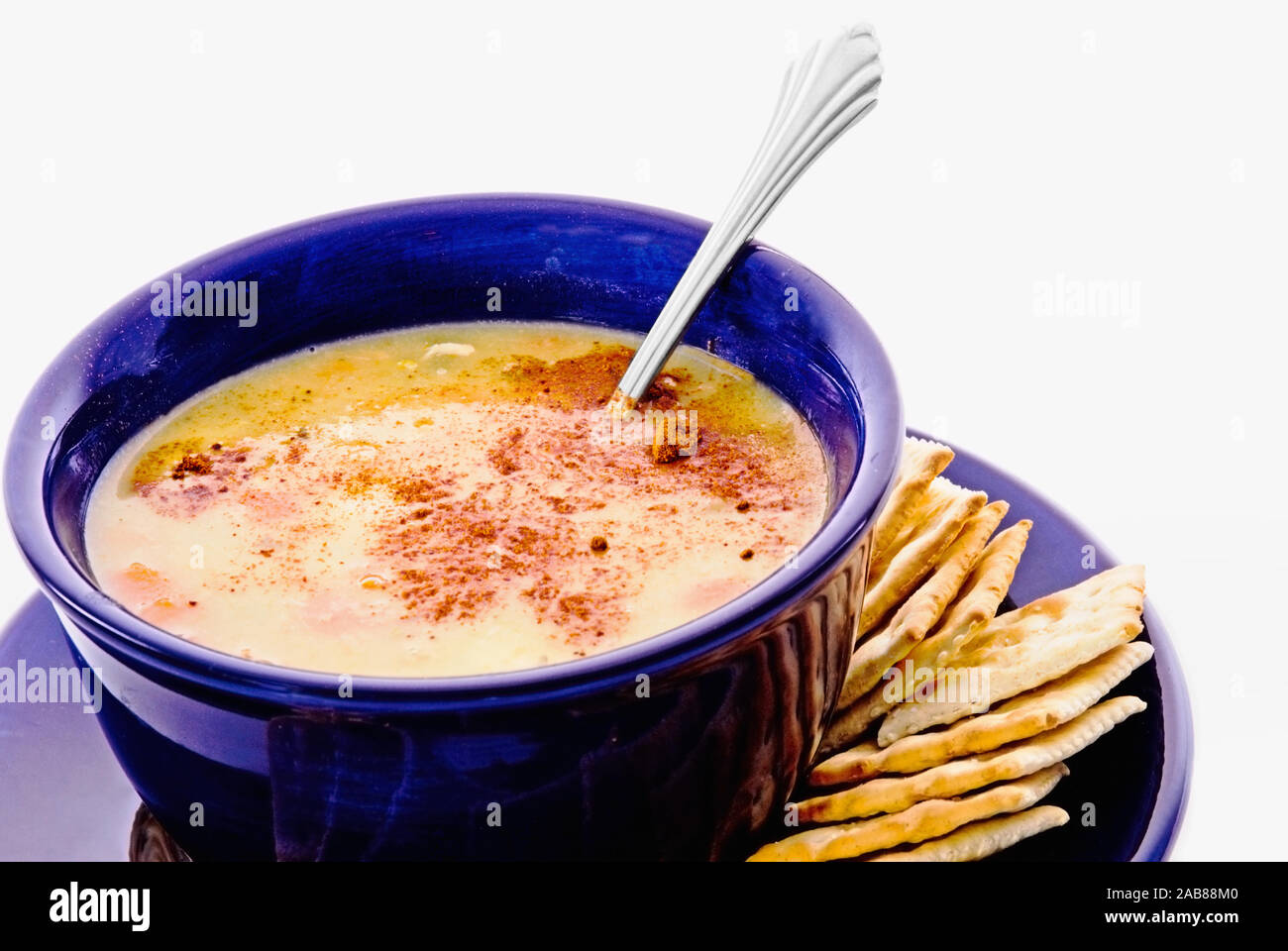 Homemade chicken noodle and vegetable soup served with saltine crackers ...