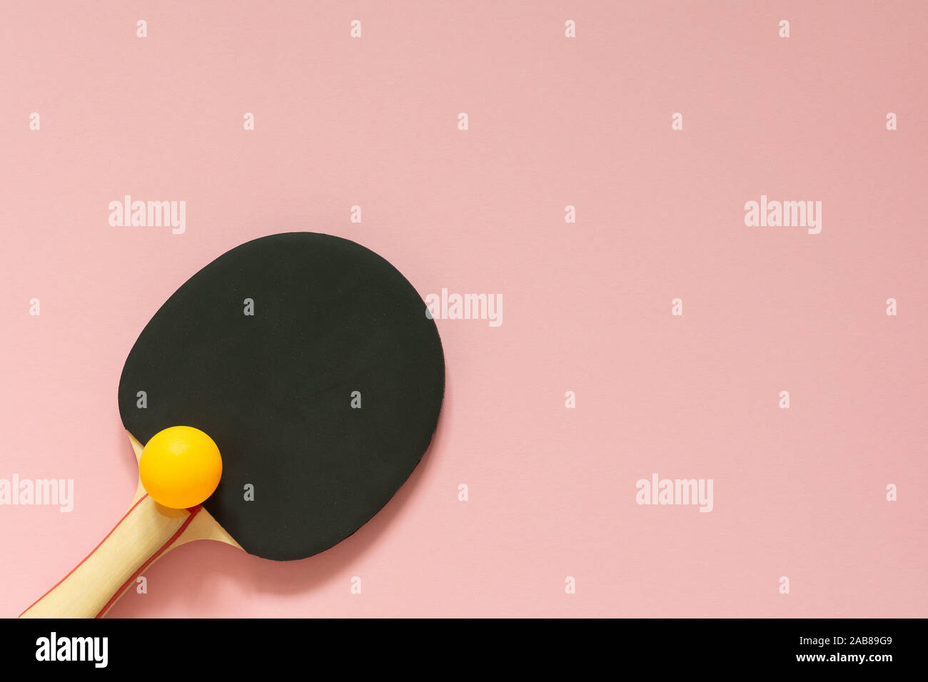 Black tennis ping pong racket isolated on a pink background, sport ...