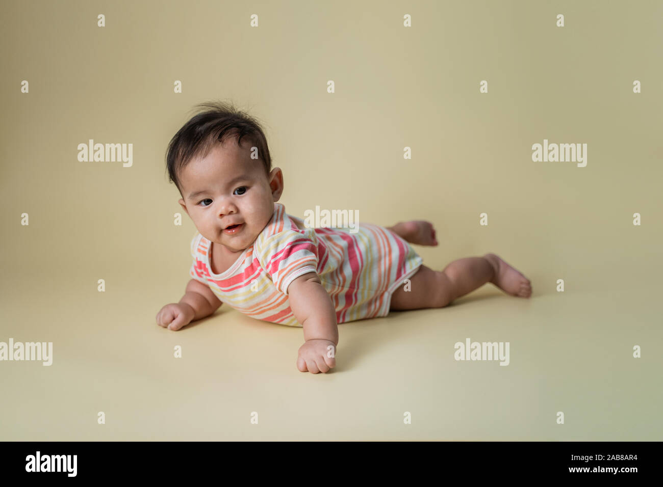 Child laying on stomach hi-res stock photography and images - Alamy