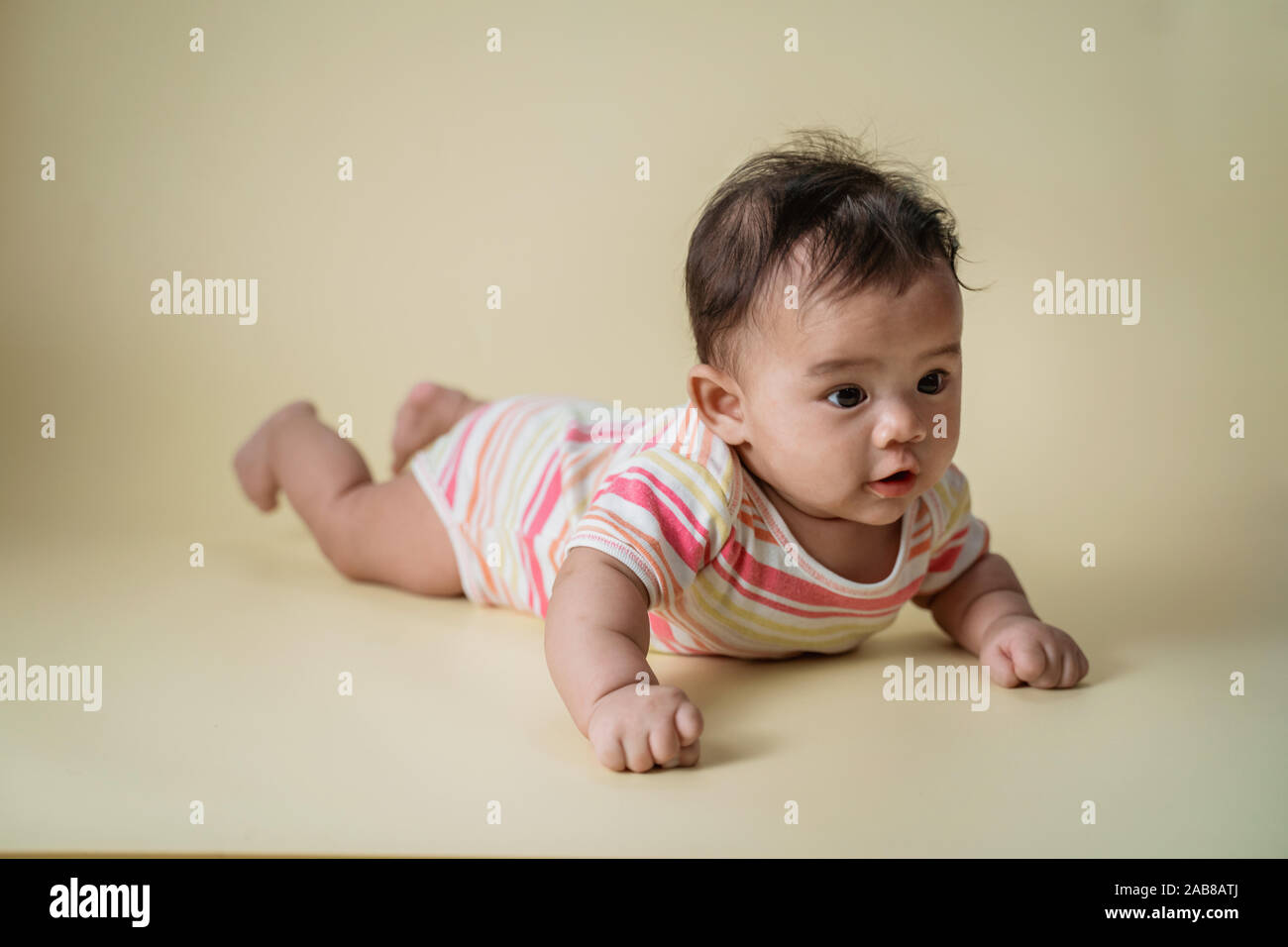 baby laying on her belly in studio Stock Photo - Alamy