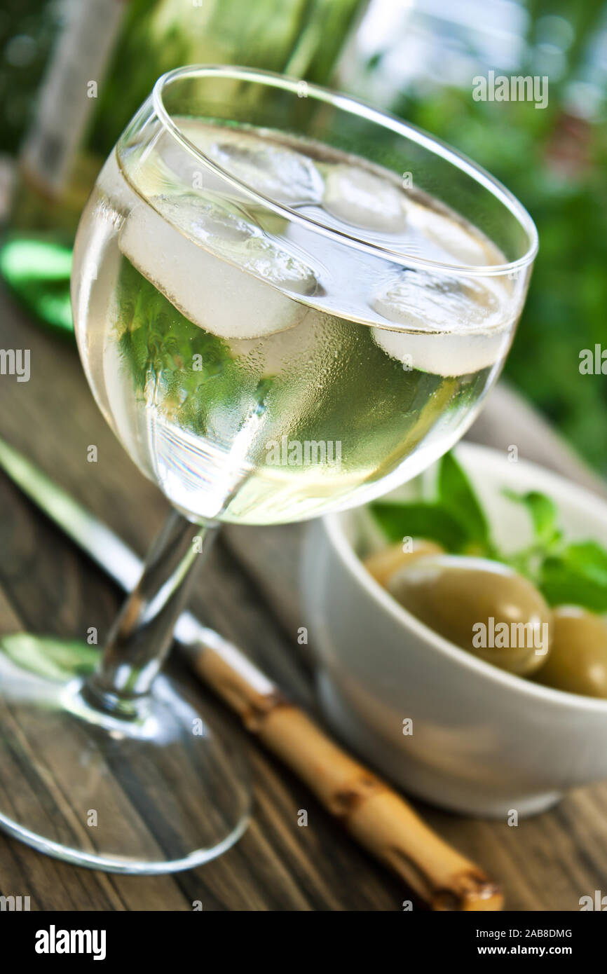 Wine and ice cubes with olives Stock Photo - Alamy