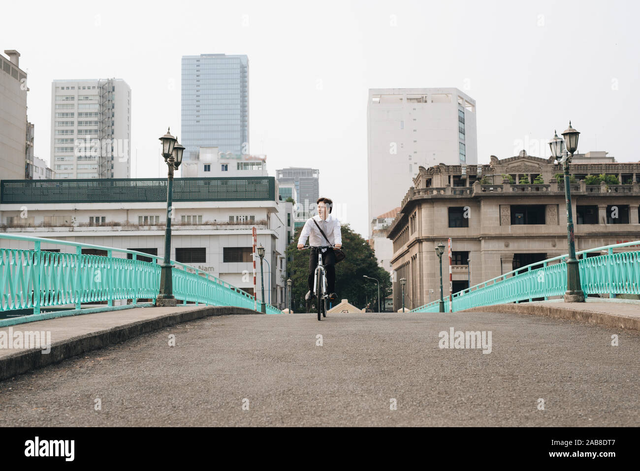 Going everywhere by his bike. Side view of young businessman looking ...