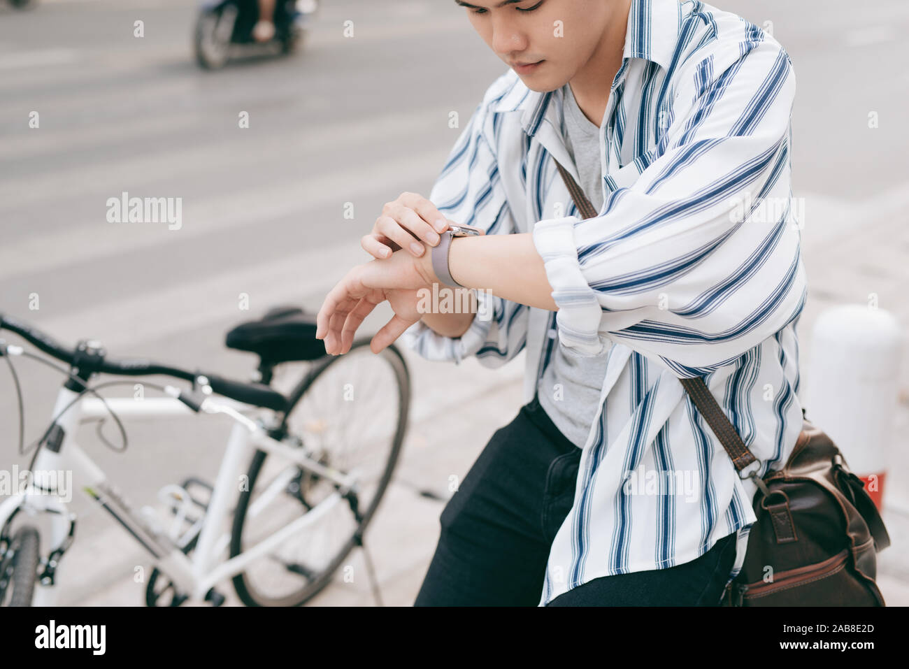 Man looking at his watch while waiting Stock Photo - Alamy