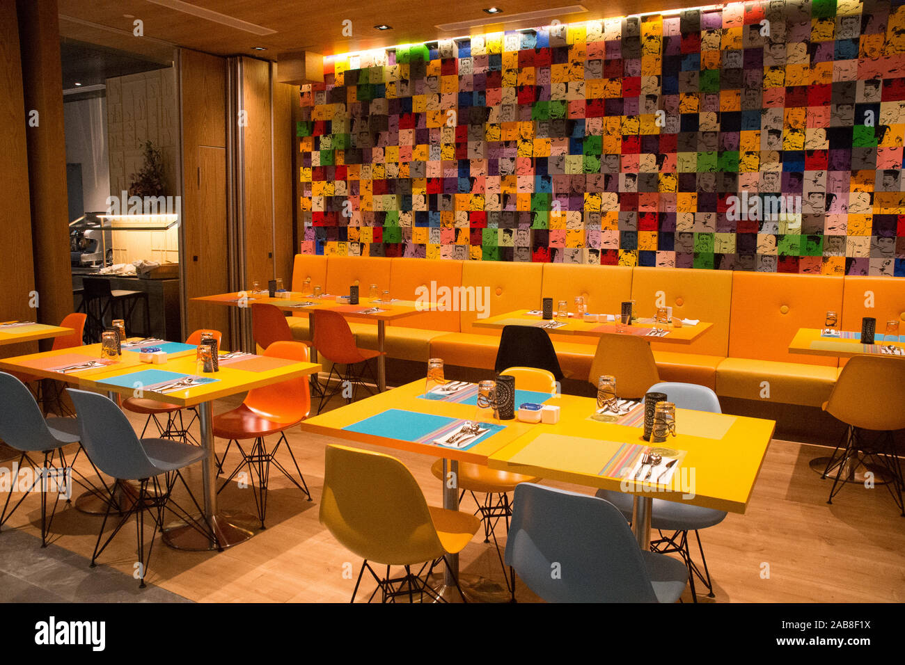 interior design of colourful restaurant with tables and chairs and ...