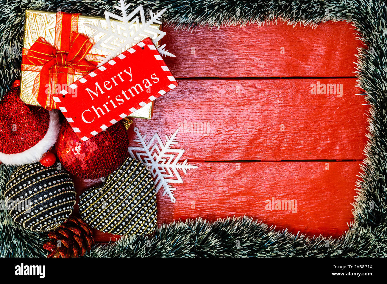 Christmas composition on red wooden board with Christmas garland and ...