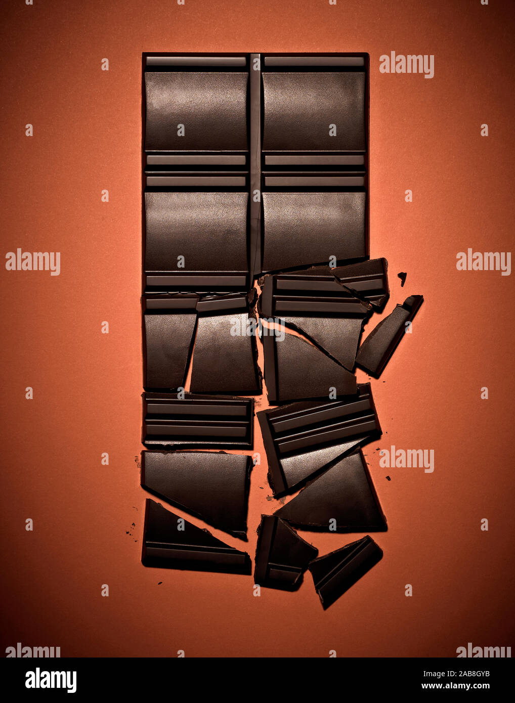 Broken Chocolate tablet slab on brown Stock Photo - Alamy