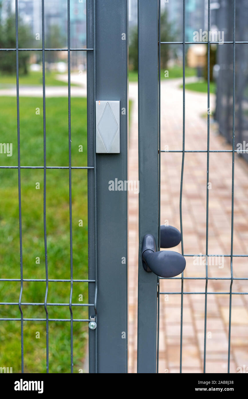 safety in modern residential buildings. fenced yard, closed gate with ...