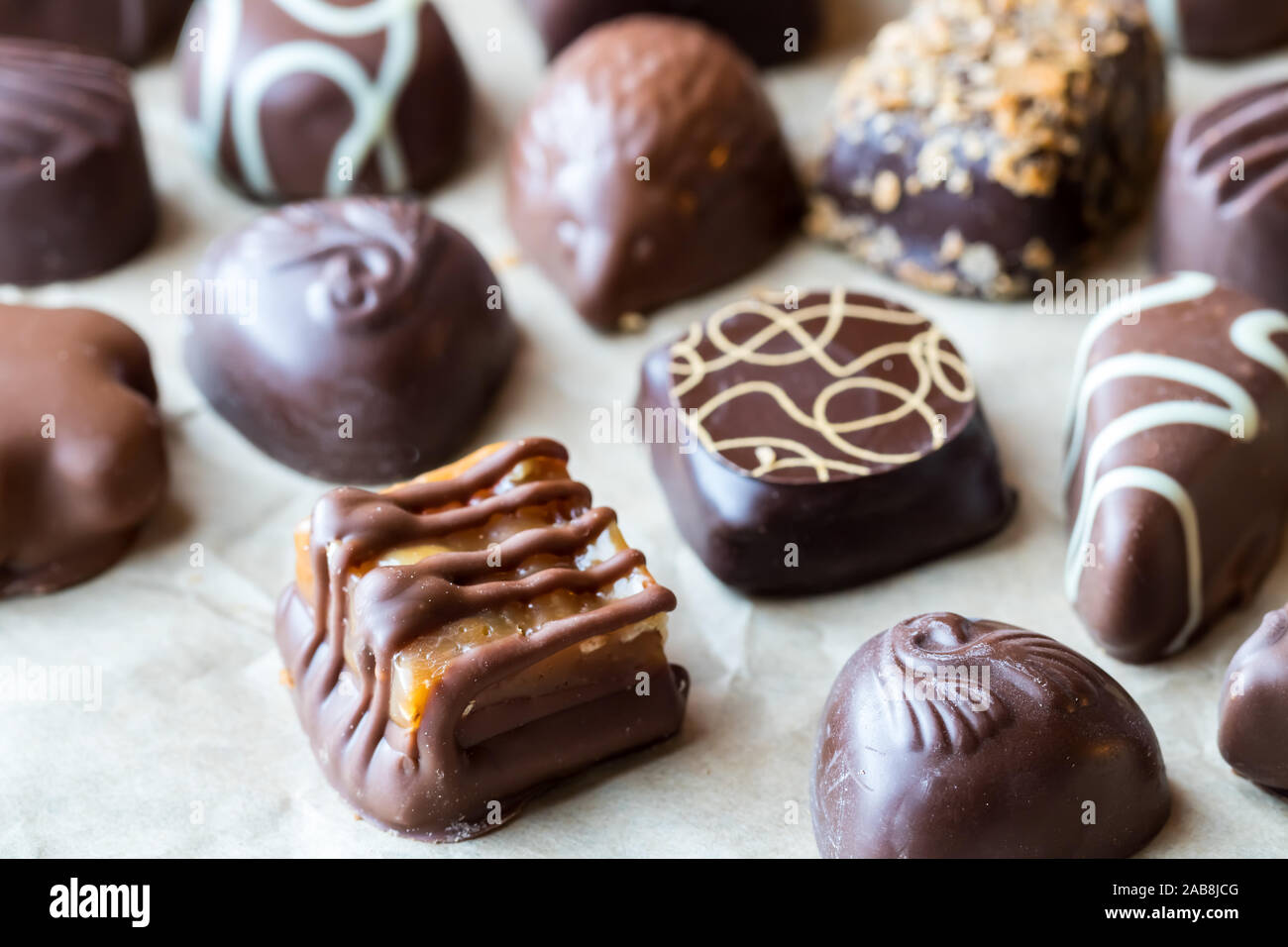 A close up view of an assortment of decorated chocolates ready for ...