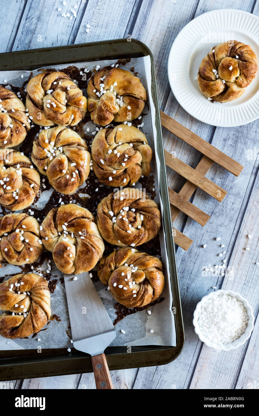 Top down view of a baking tray full of warm Swedish cinnamon buns ...