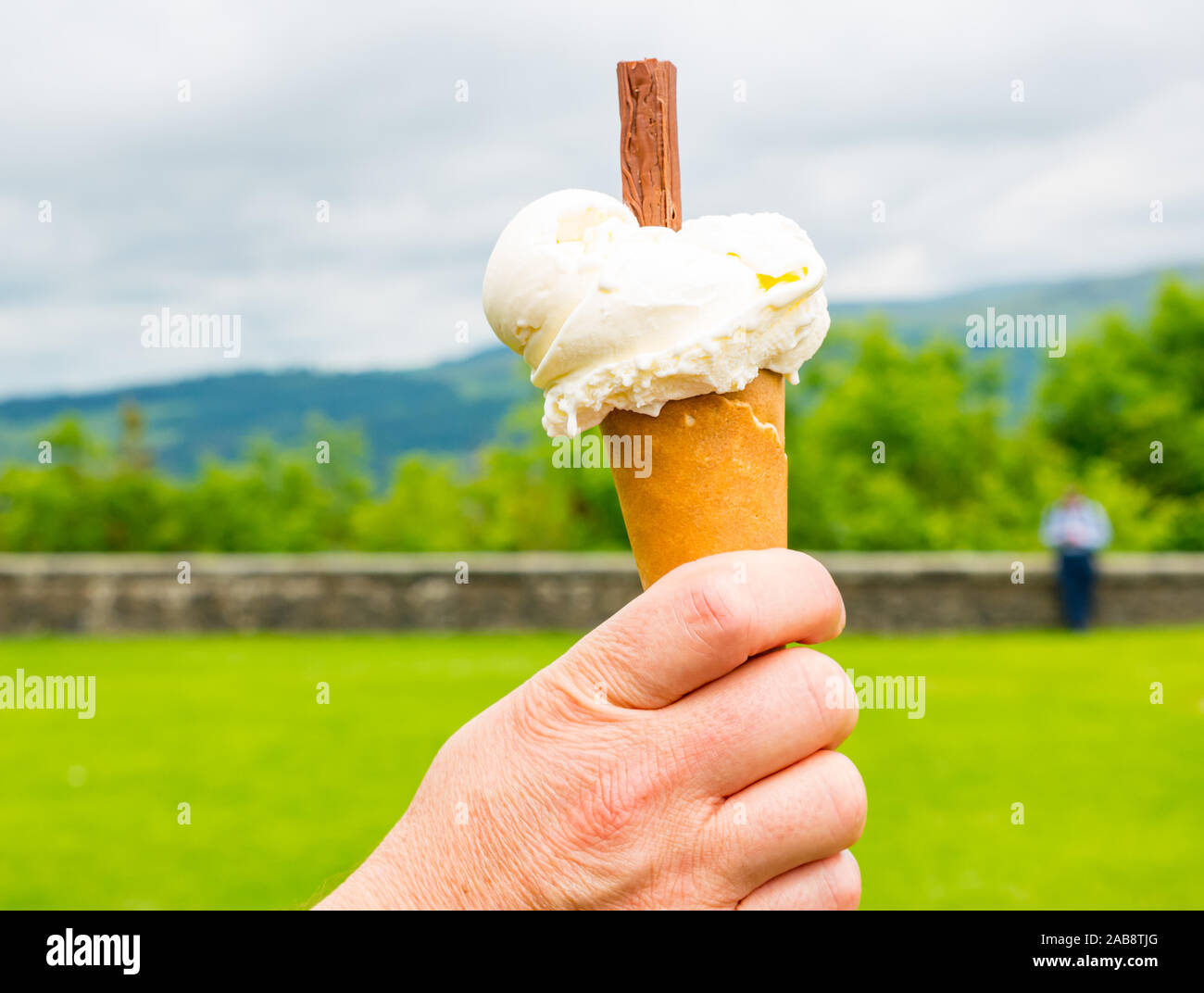 Male hand holding vanilla ice cream cone, Stirling Castle esplanade ...