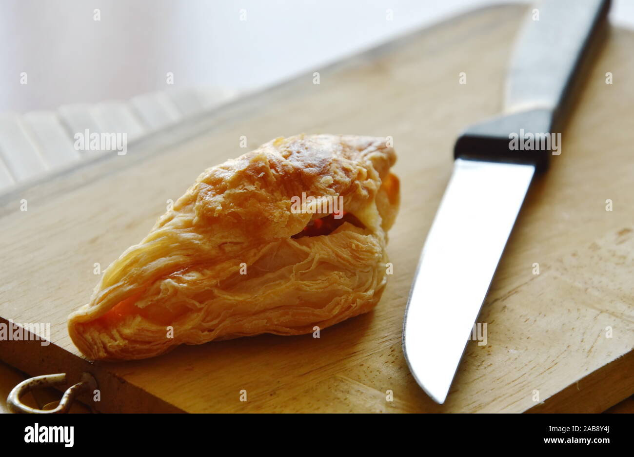 crispy pie filled pork sausage and mashed bean with wooden chop block ...