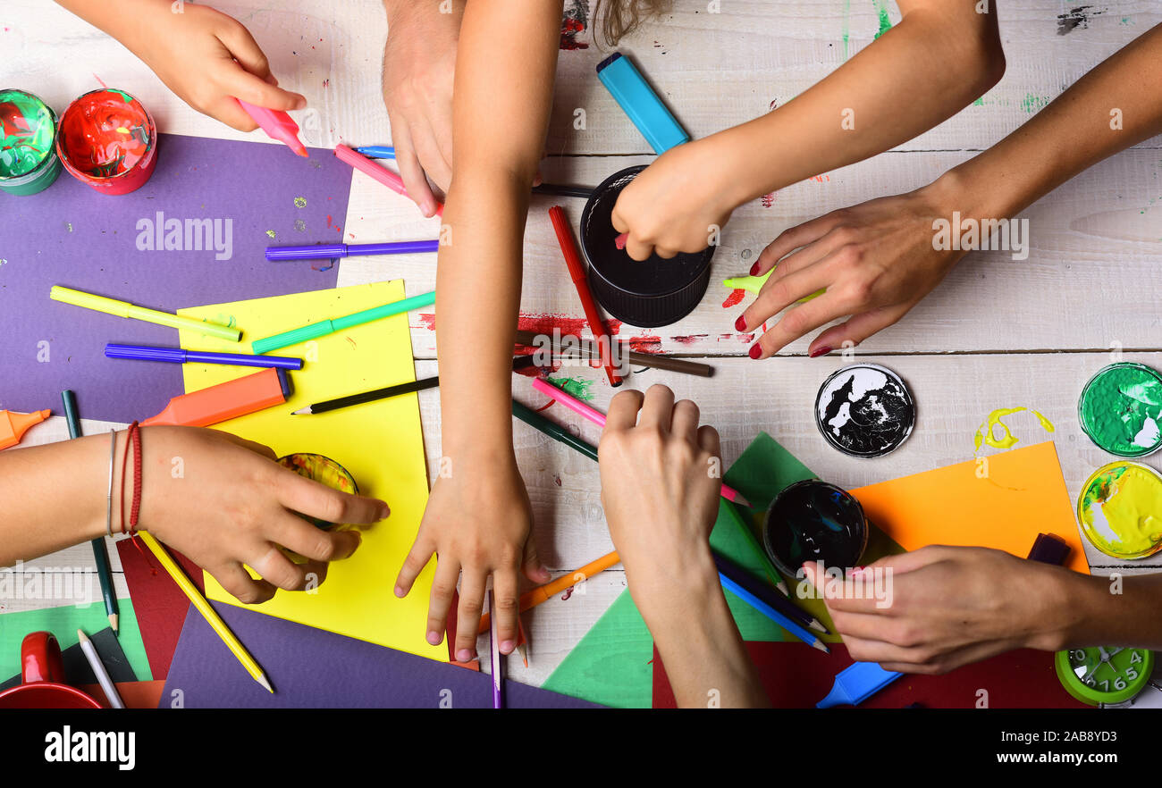 Artists hands with stationery and colored paper. Art supplies in male ...