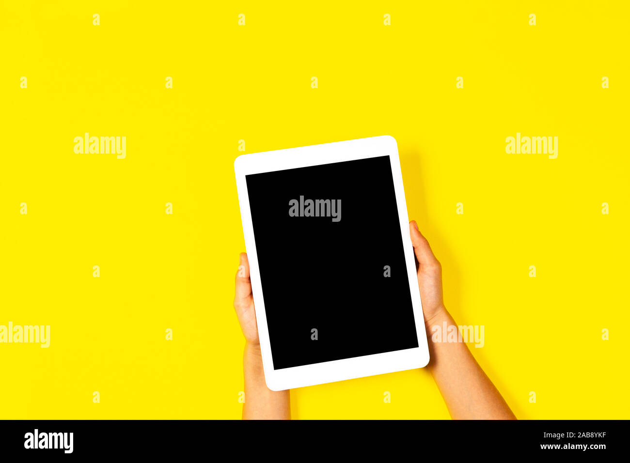 Child hands holding tablet device hi-res stock photography and images ...