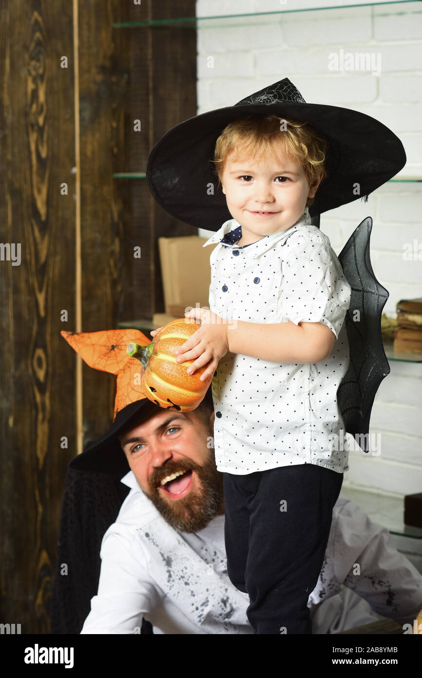 Witcher and little magician make Halloween decor. Guy and kid with ...