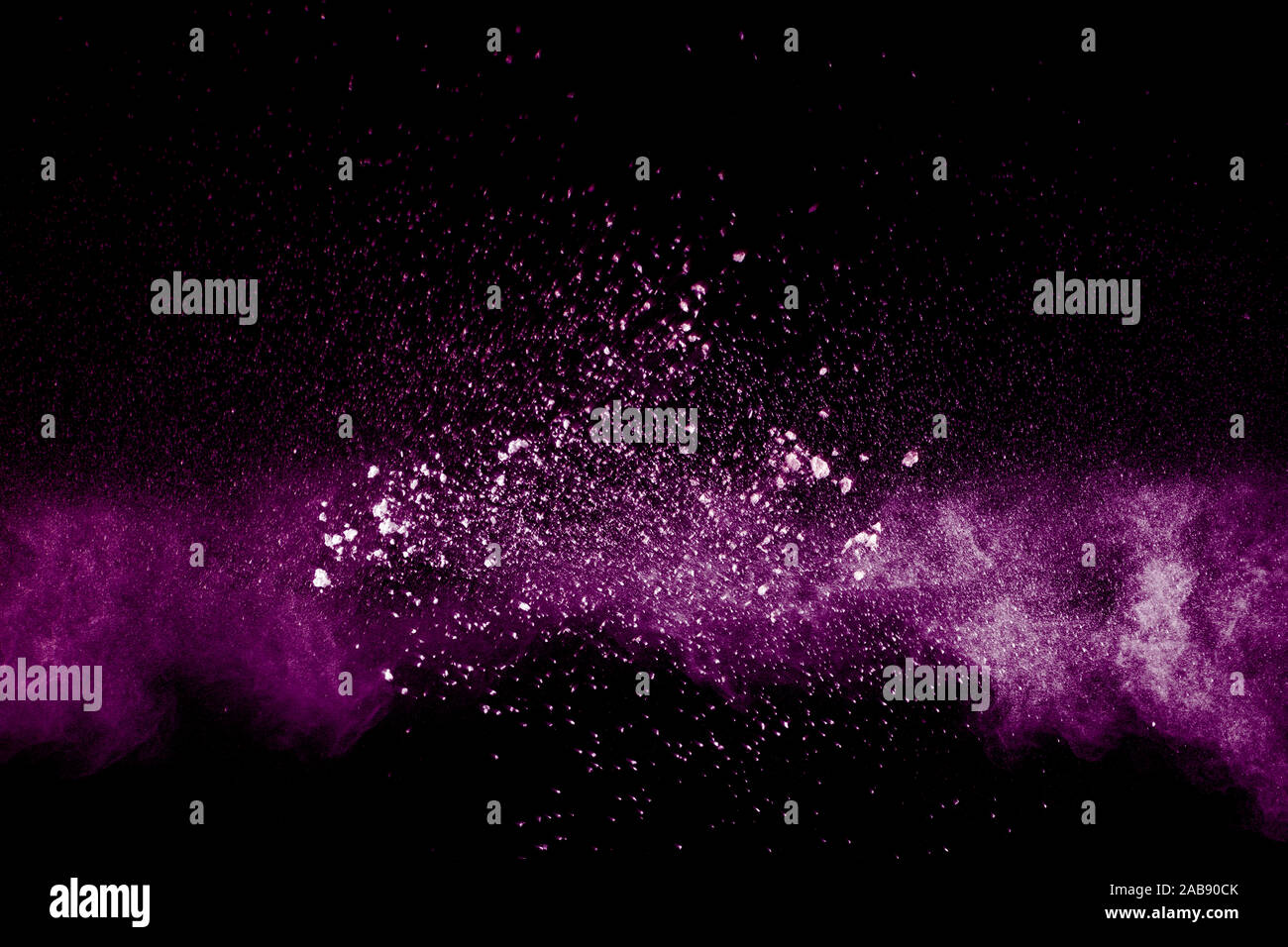 Purple color powder explosion cloud on black background.Closeup of ...