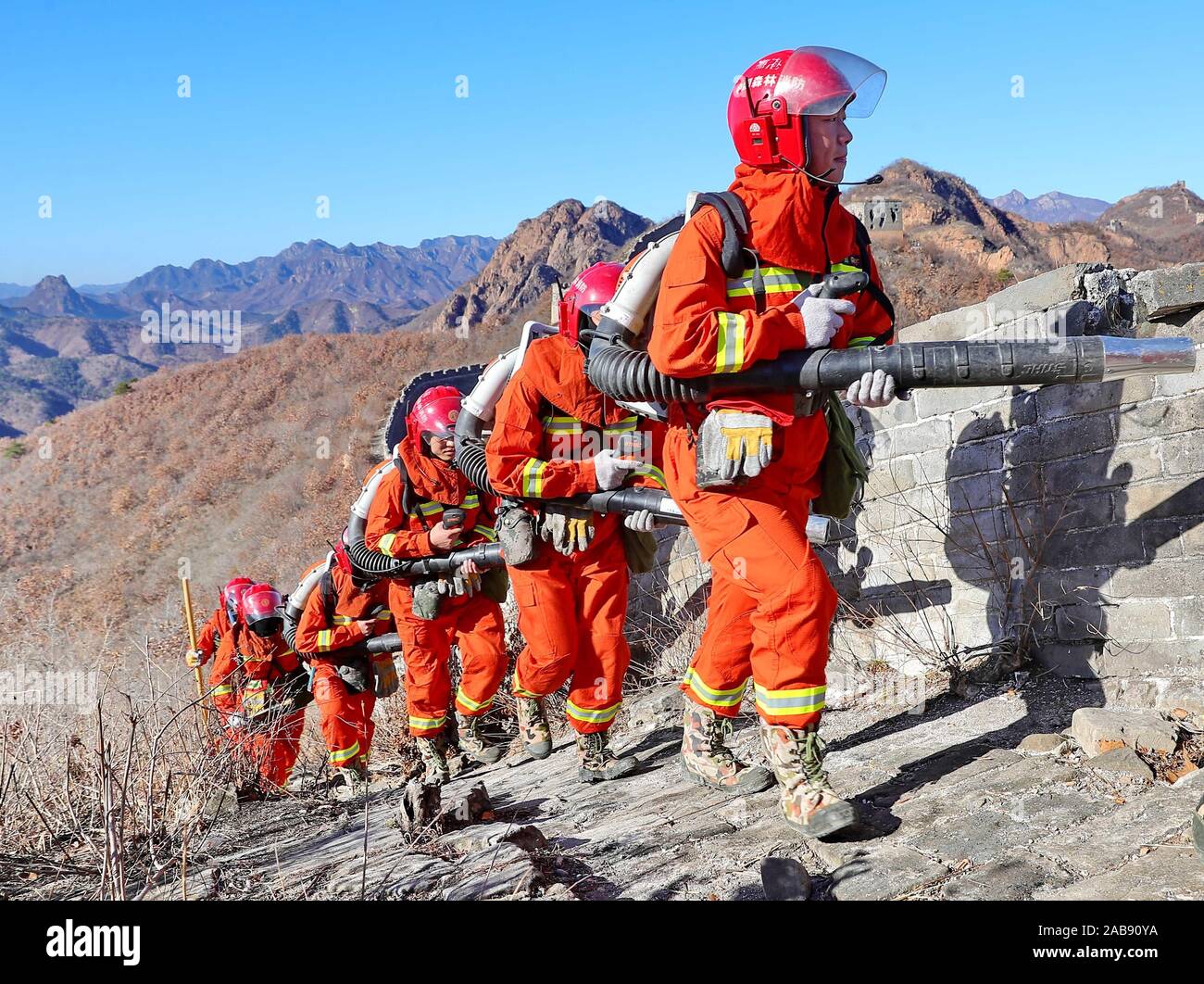Chinese firefighters from the local forest firefighting brigade patrol ...
